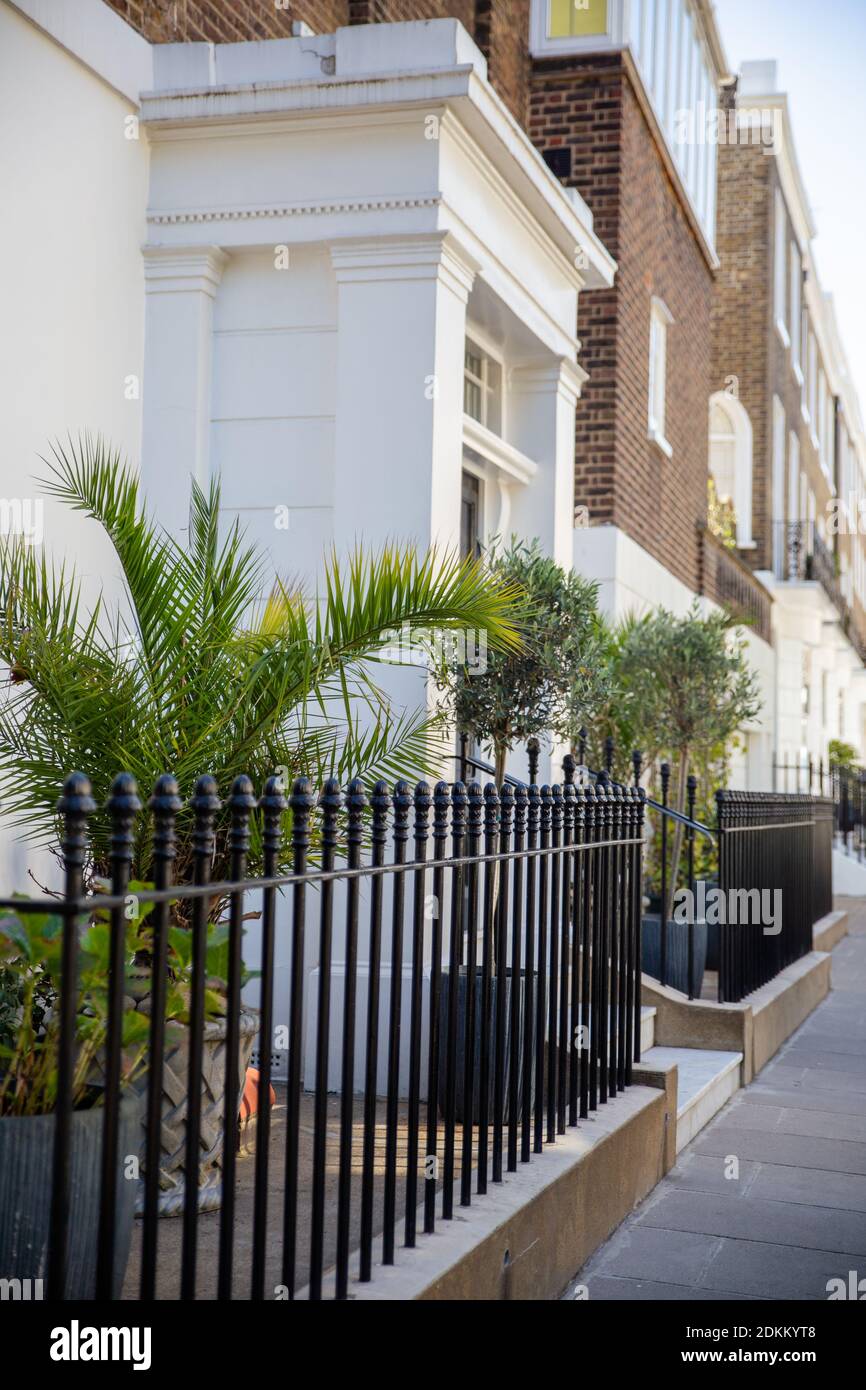White British apartment with columns and plants decorating the entrance ...