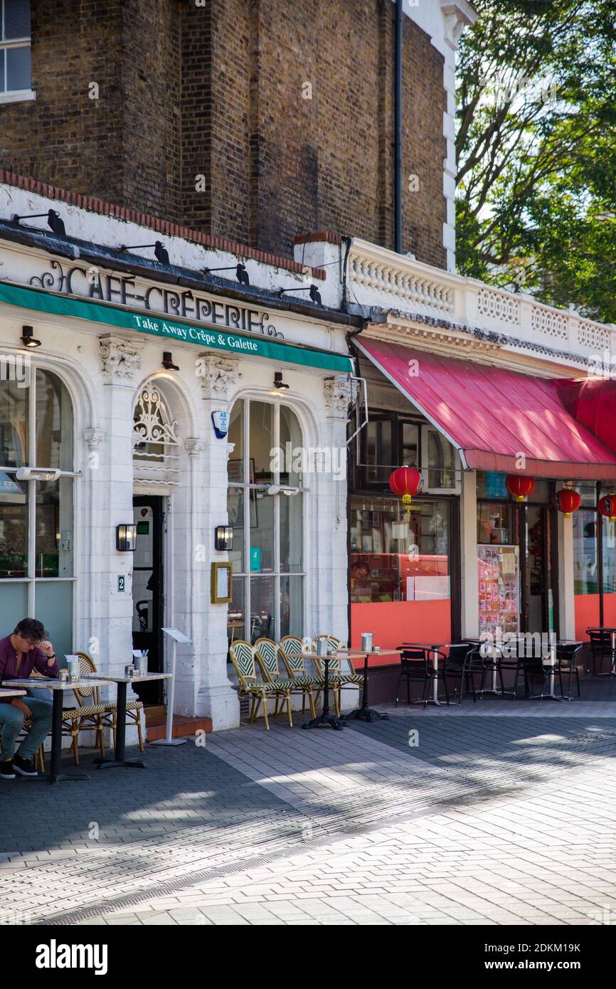 British cafe next to a Chinese food restaurant Stock Photo - Alamy