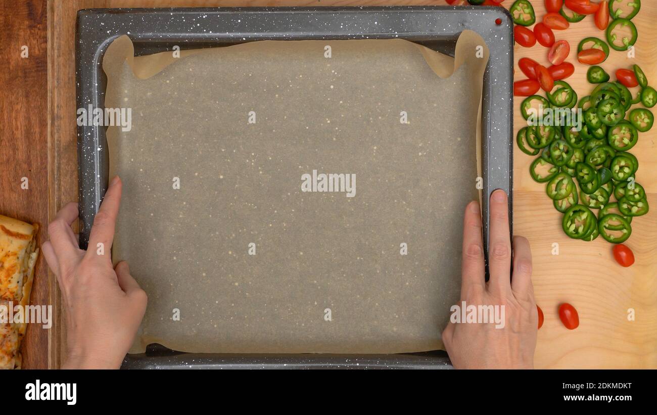 Baking tray with baking paper close up on rustic wooden background ...