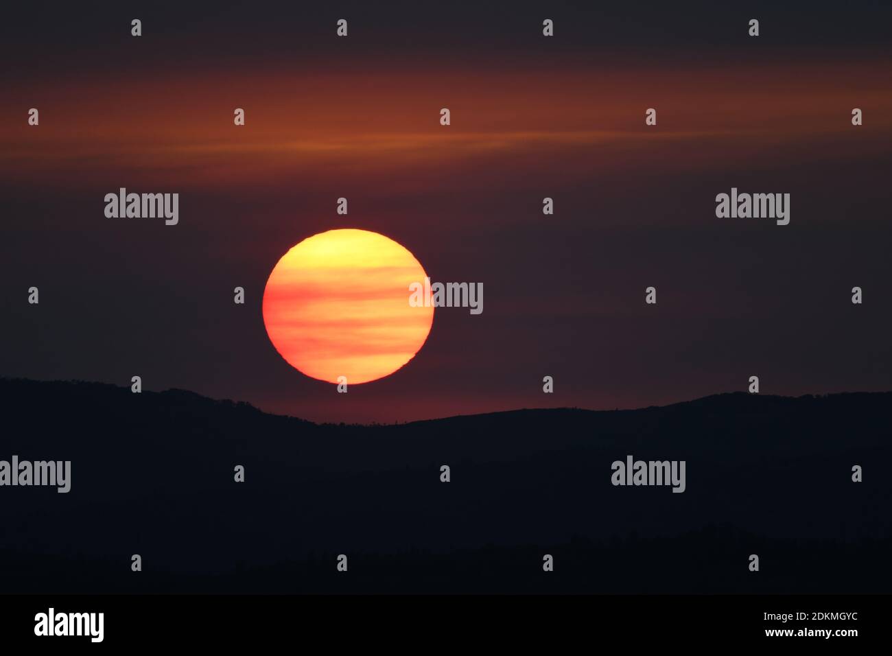 sunset scene with smoke in the air Stock Photo - Alamy