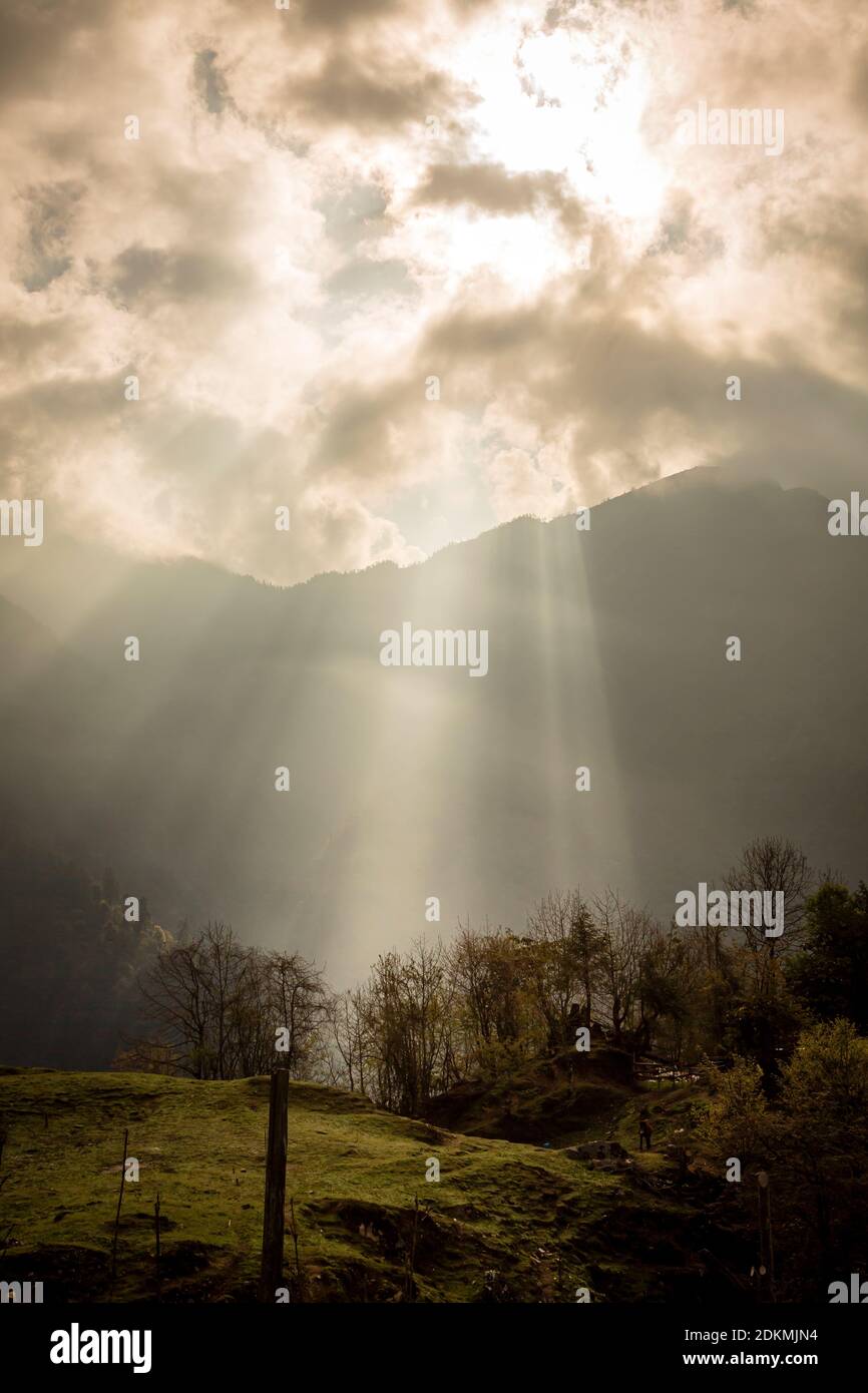 View of sun rays on a hilltop on the Gochela trek to the Kanchenjunga ...