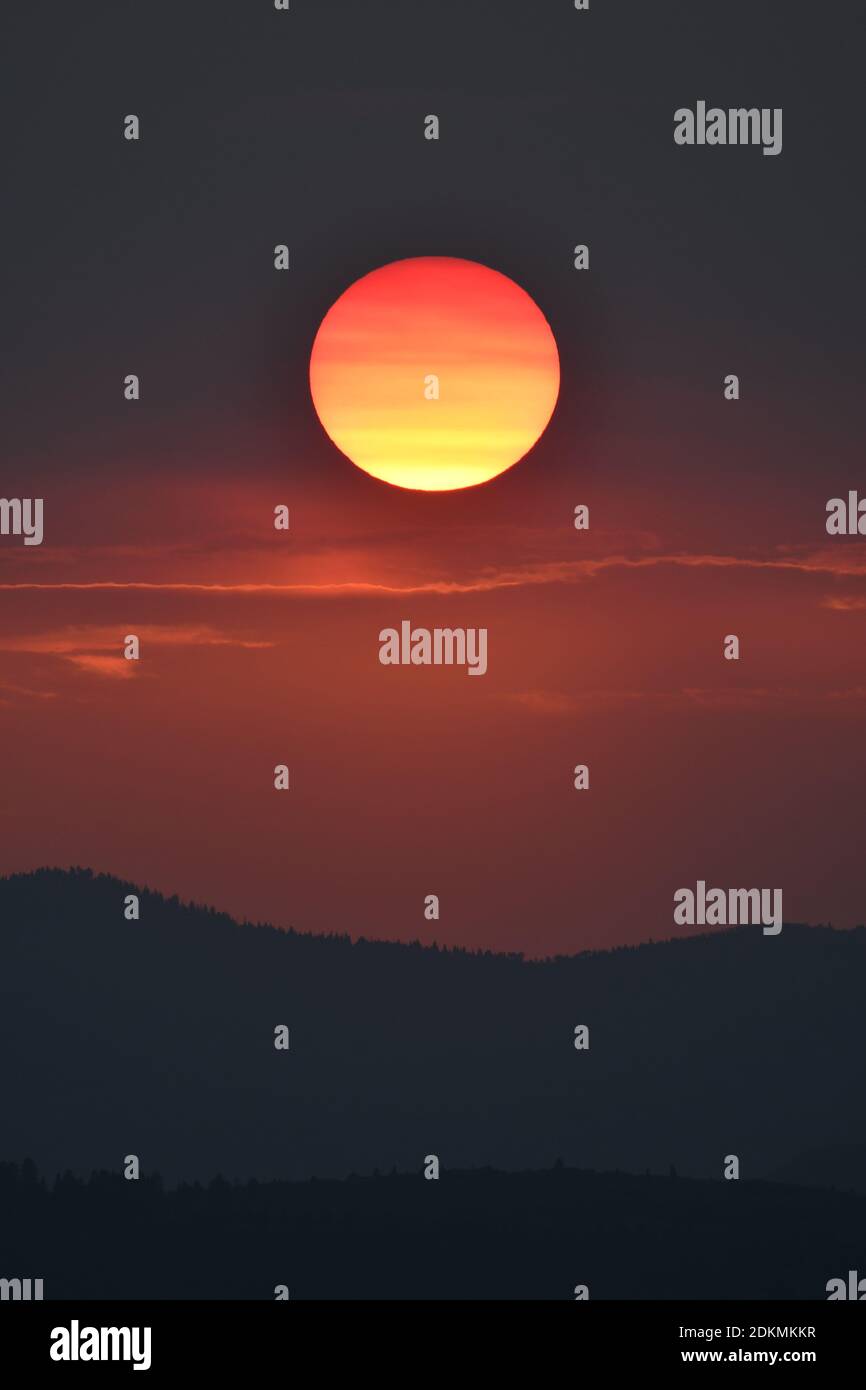 sunset scene with smoke in the air Stock Photo - Alamy