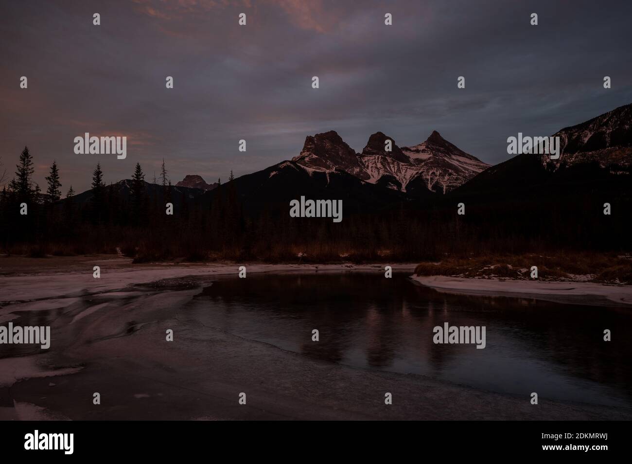 Three Sisters mountain peaks in Canmore Alberta before sunrise Stock ...