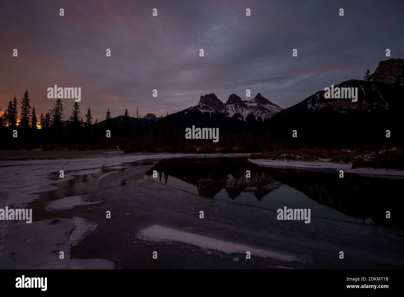 Three Sisters mountain peaks in Canmore Alberta before sunrise Stock ...
