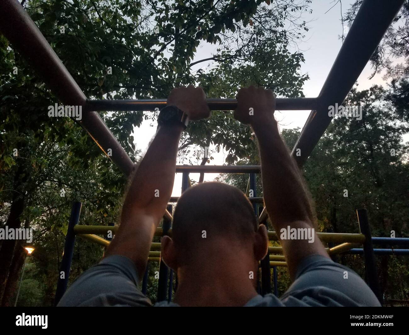 Man monkey bars playground hi-res stock photography and images - Alamy