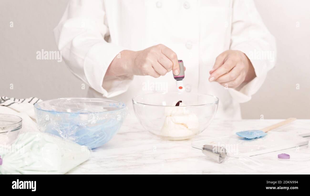 Mixing food coloring with buttercream frosting Stock Photo - Alamy