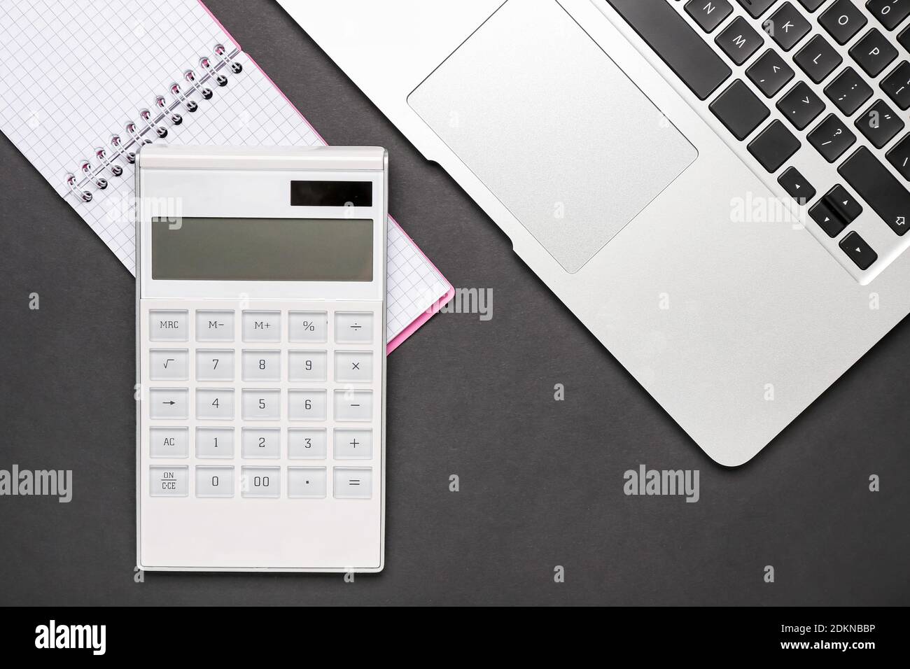 Modern calculator, notebook and laptop on dark background Stock Photo ...