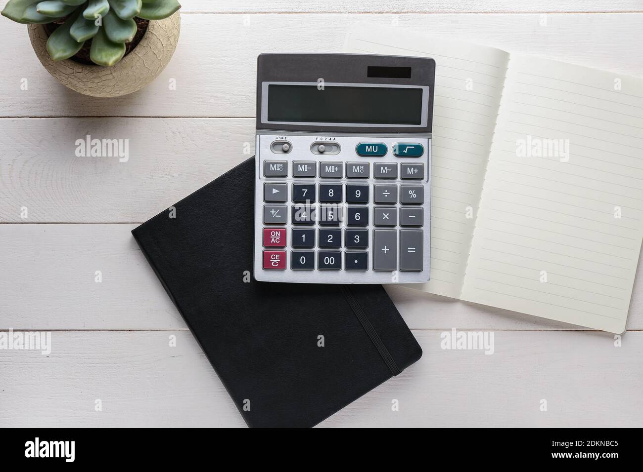 Modern calculator and notebooks on wooden background Stock Photo - Alamy