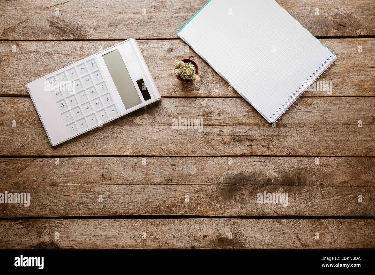 Modern calculator and notebook on wooden background Stock Photo - Alamy