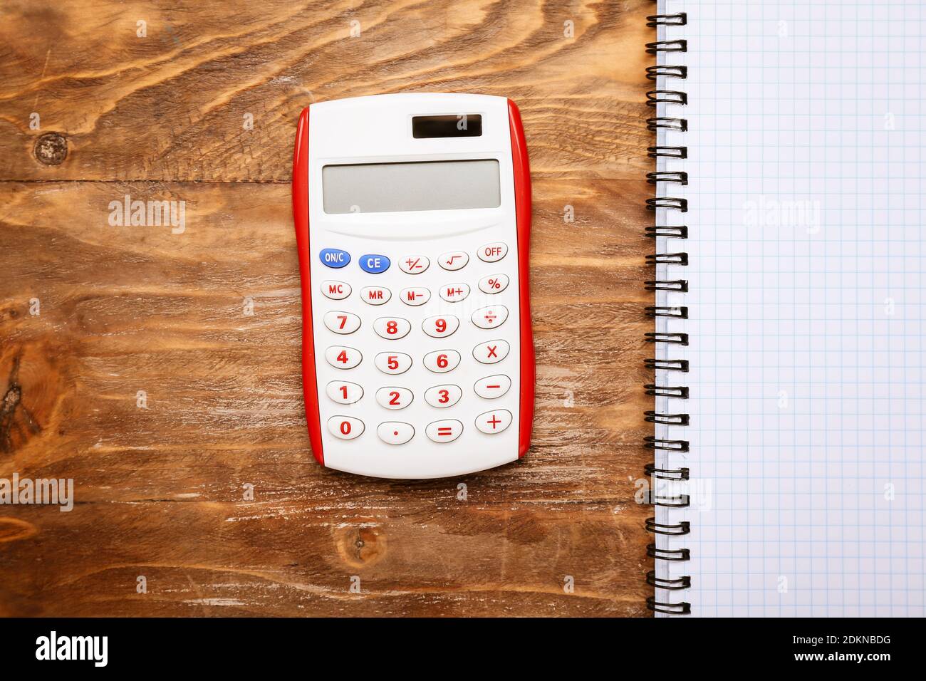 Modern calculator and notebook on wooden background Stock Photo - Alamy