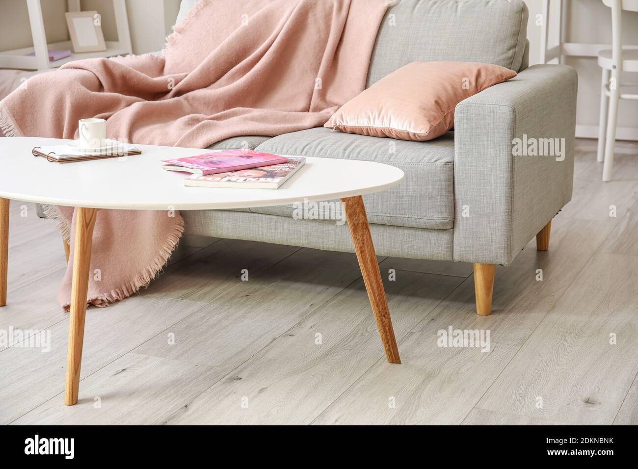 Stylish interior of modern living room with table Stock Photo - Alamy