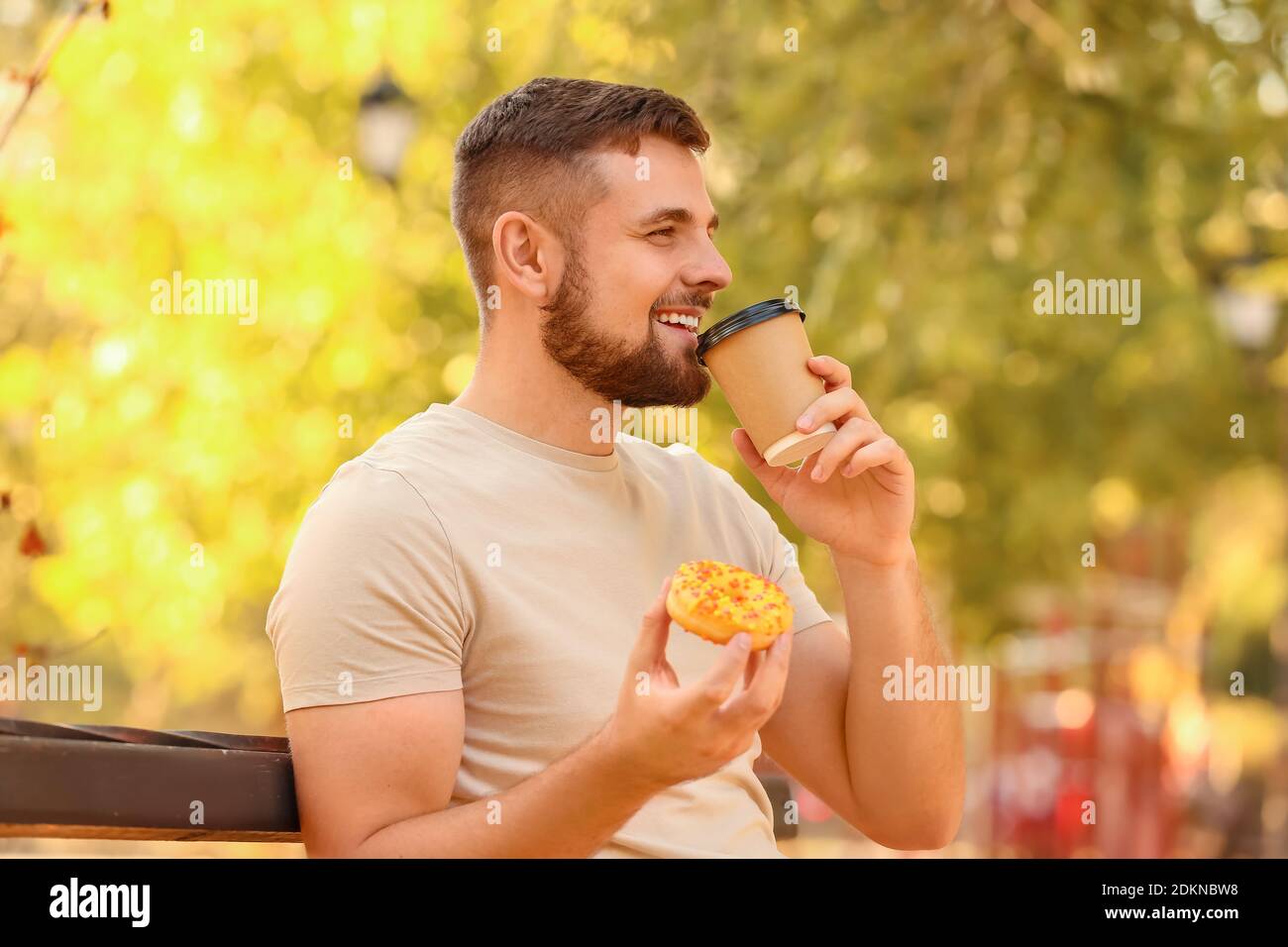 Man eating sweet donut in hi-res stock photography and images - Alamy