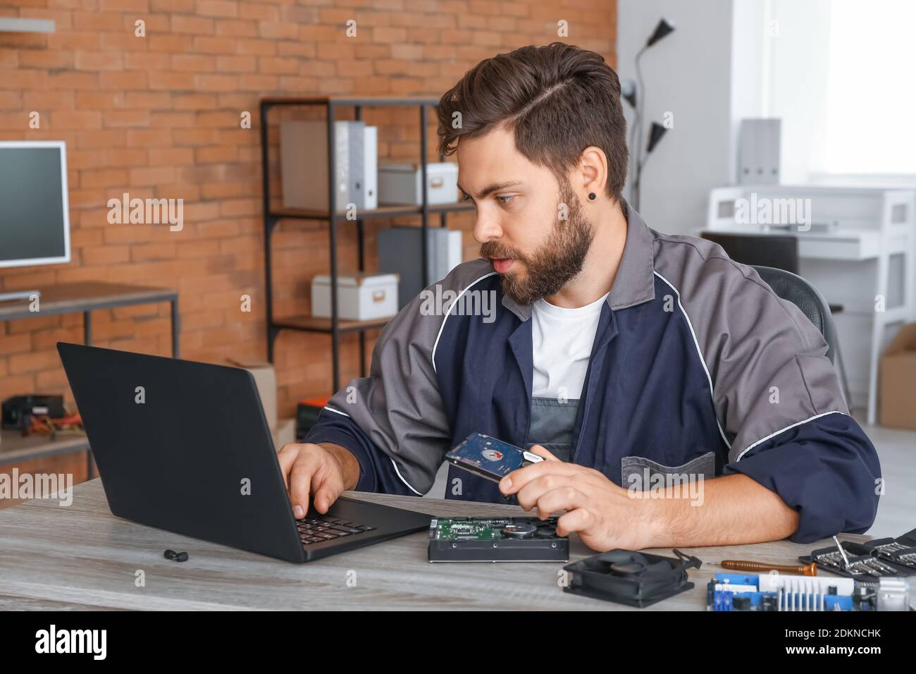 Technician repairing computer in service center Stock Photo - Alamy
