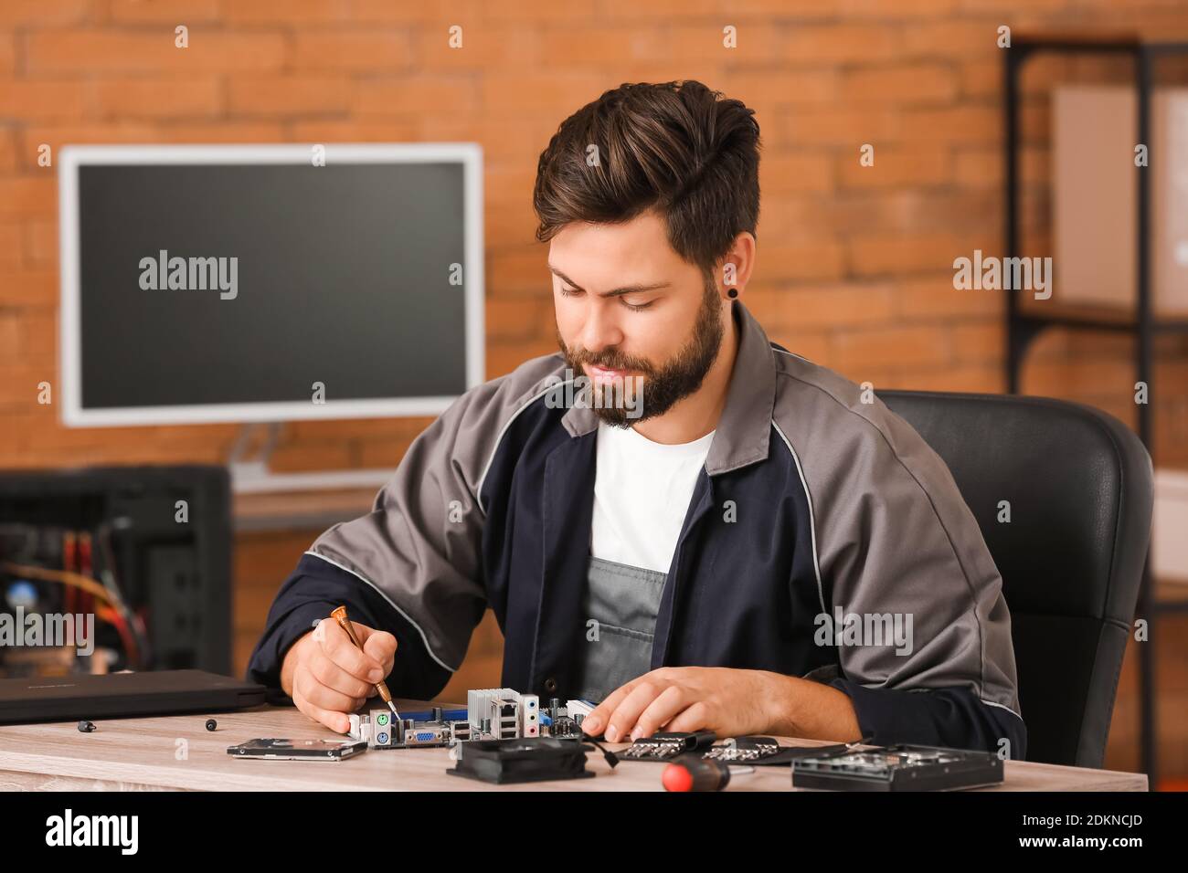 Technician repairing computer in service center Stock Photo - Alamy
