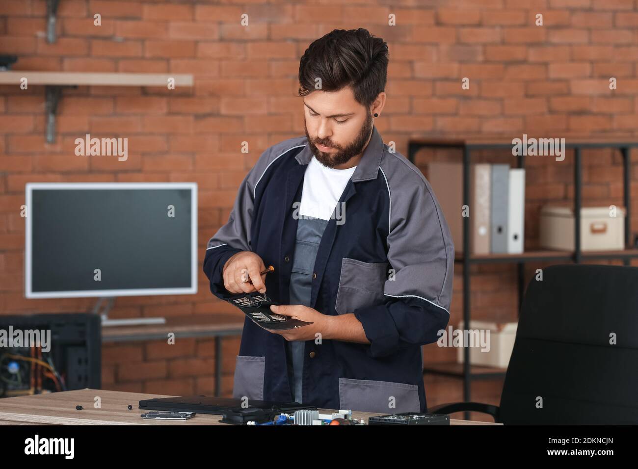 Technician repairing computer in service center Stock Photo - Alamy