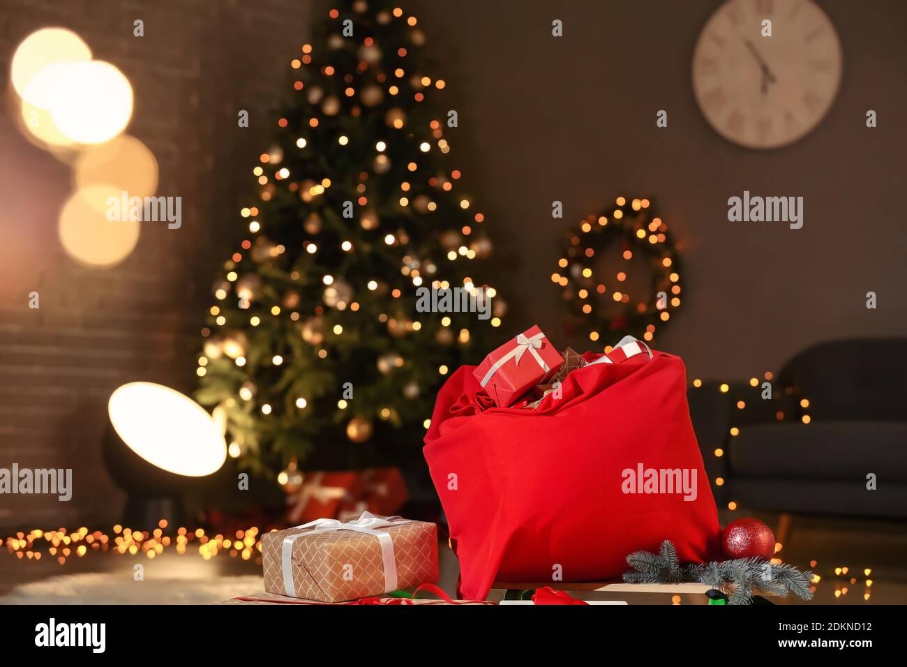 Santa bag with Christmas gifts in room at night Stock Photo - Alamy