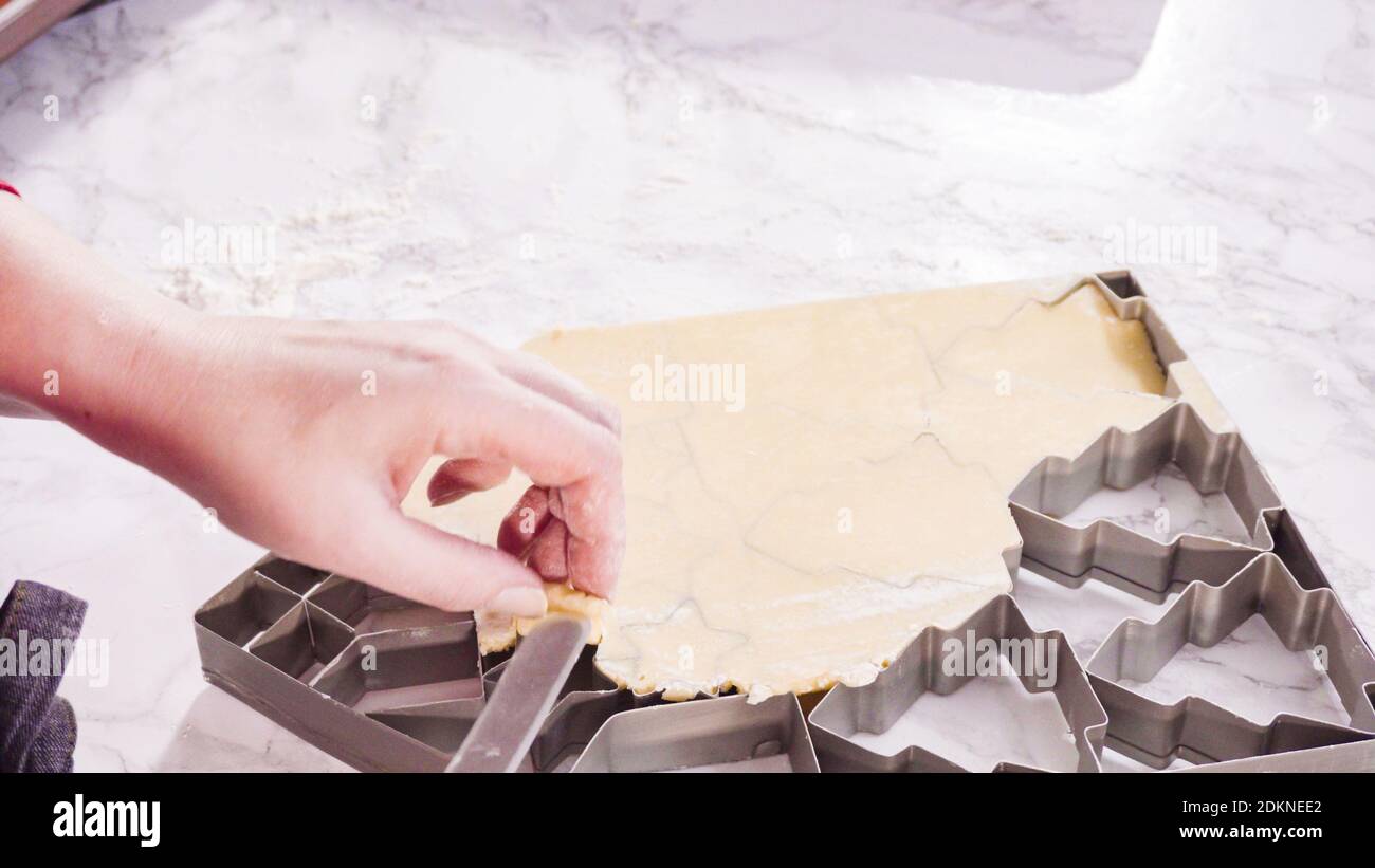Cutting out sugar cookies with giant Christmas cookie cutter Stock ...