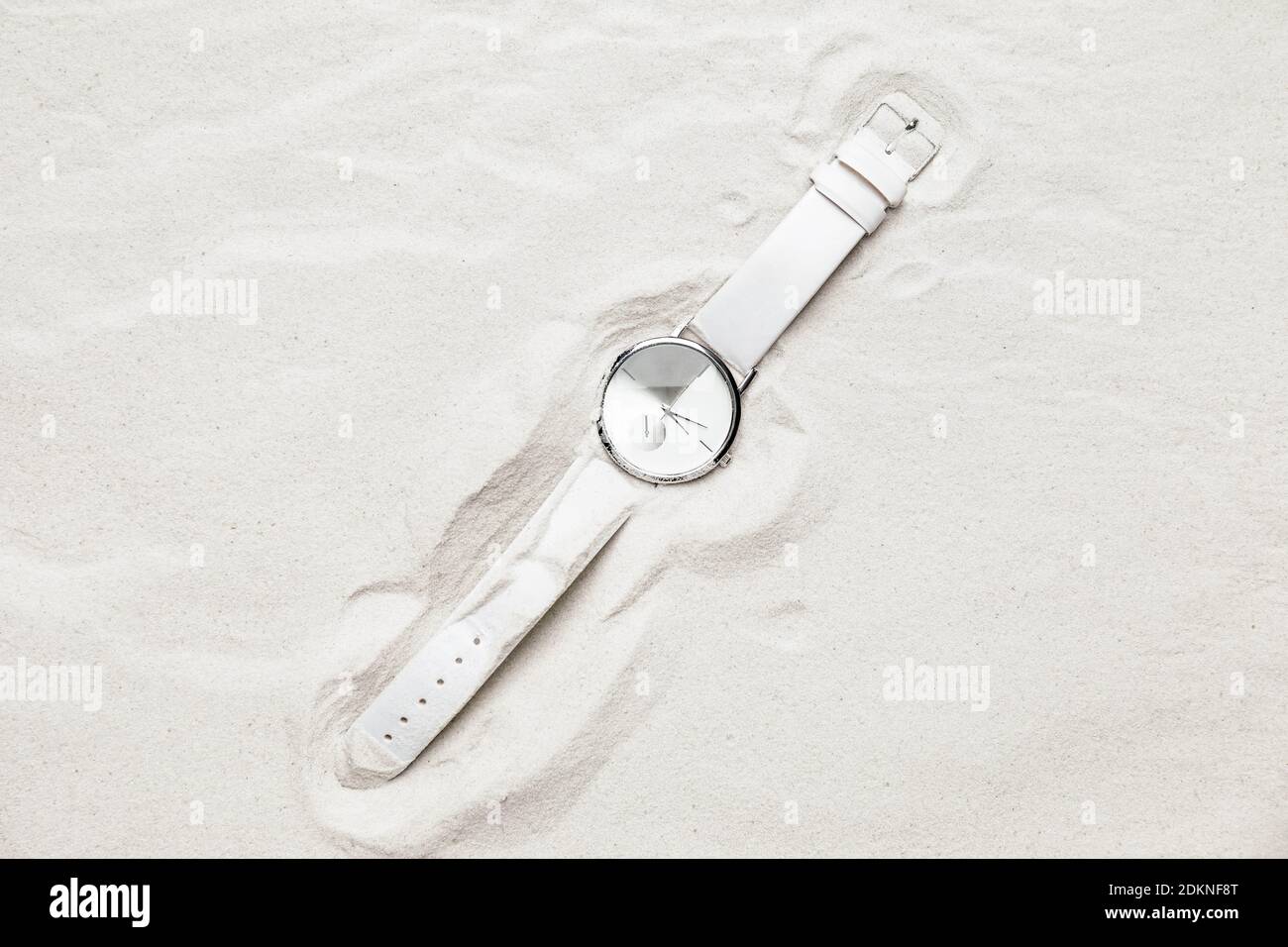 Wrist watch on beach sand Stock Photo - Alamy