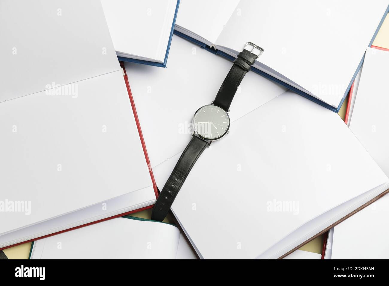 Wrist watch on open books Stock Photo - Alamy