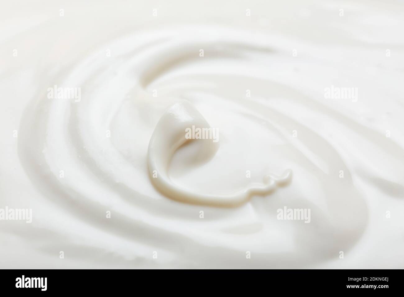 Liquid white chocolate on white background Stock Photo - Alamy