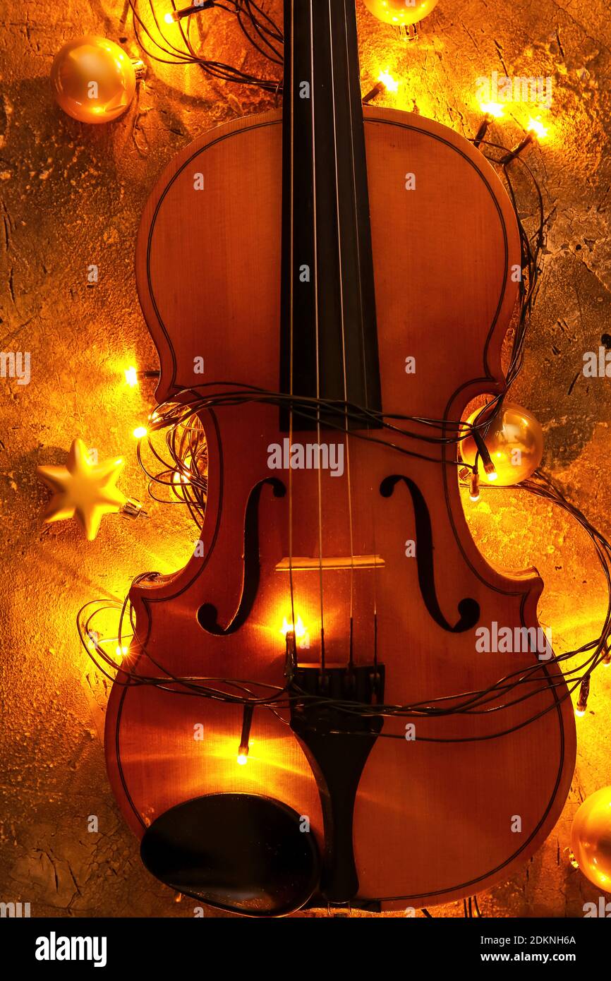 Violin with Christmas lights and decor on grunge background Stock Photo ...