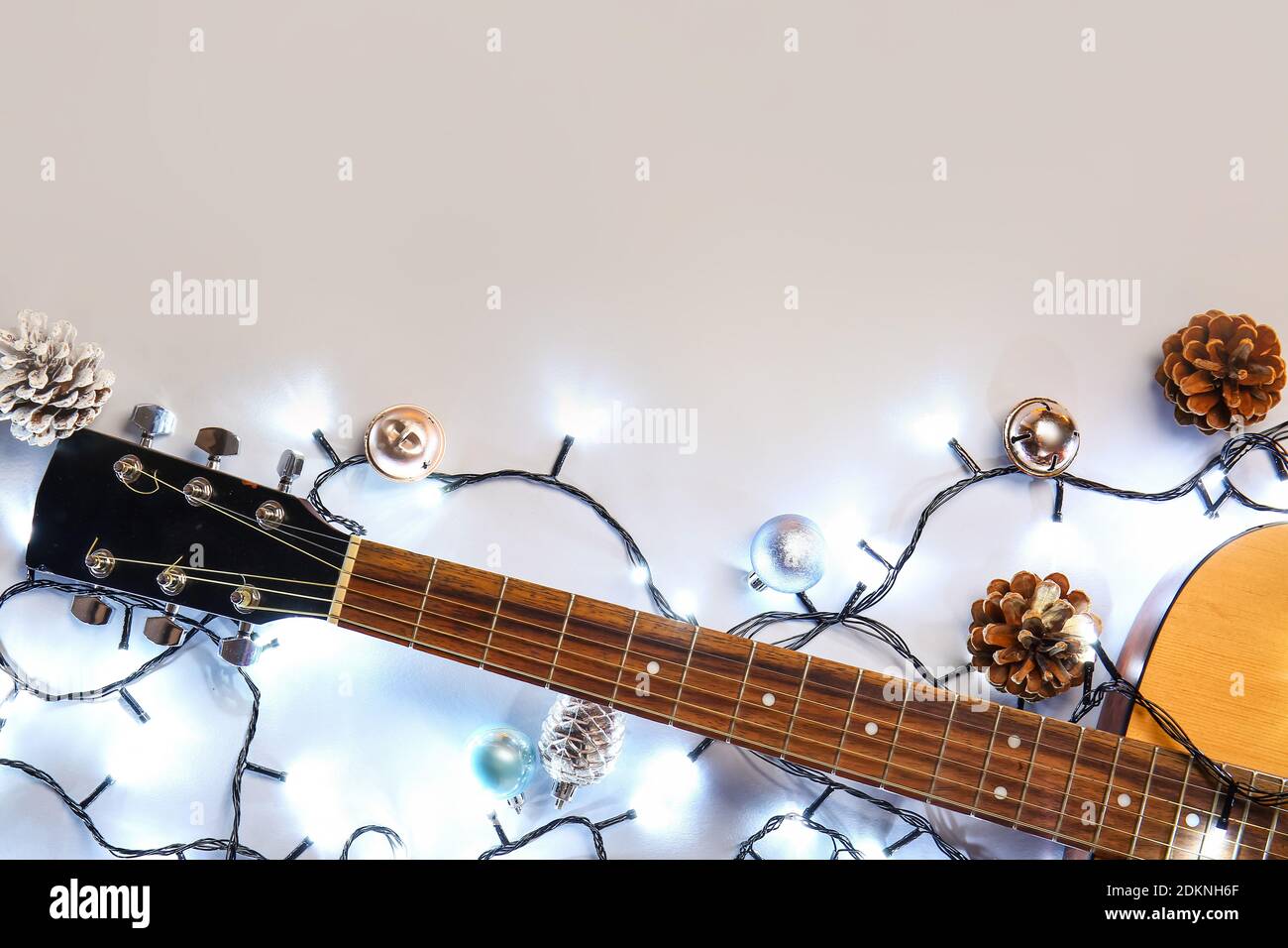 Guitar with Christmas lights and decor on white background Stock Photo ...