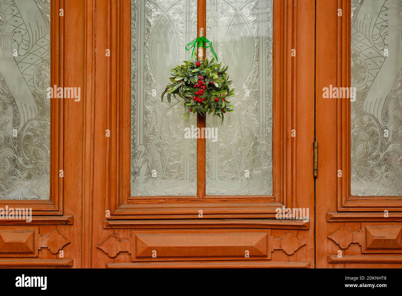 Mistletoe branch on wooden door, outdoors Stock Photo - Alamy
