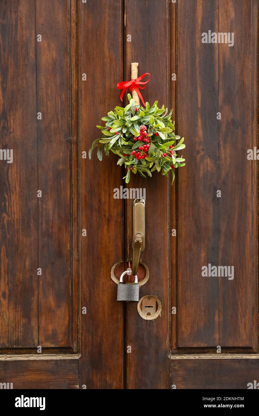 Mistletoe branch on wooden door, outdoors Stock Photo - Alamy