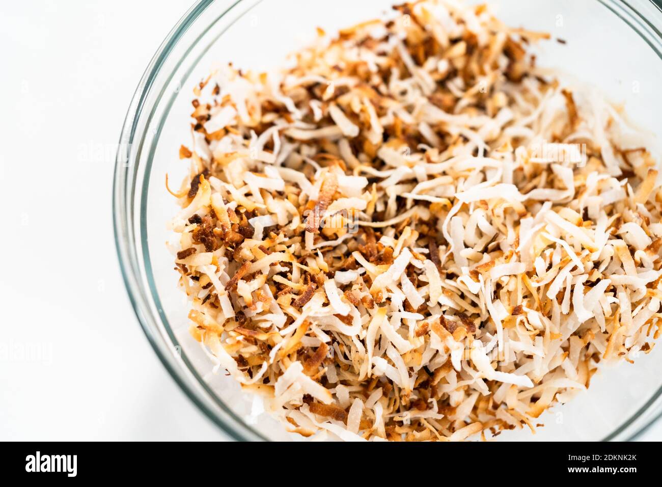 Roasted coconut flakes in a glass bowl Stock Photo - Alamy