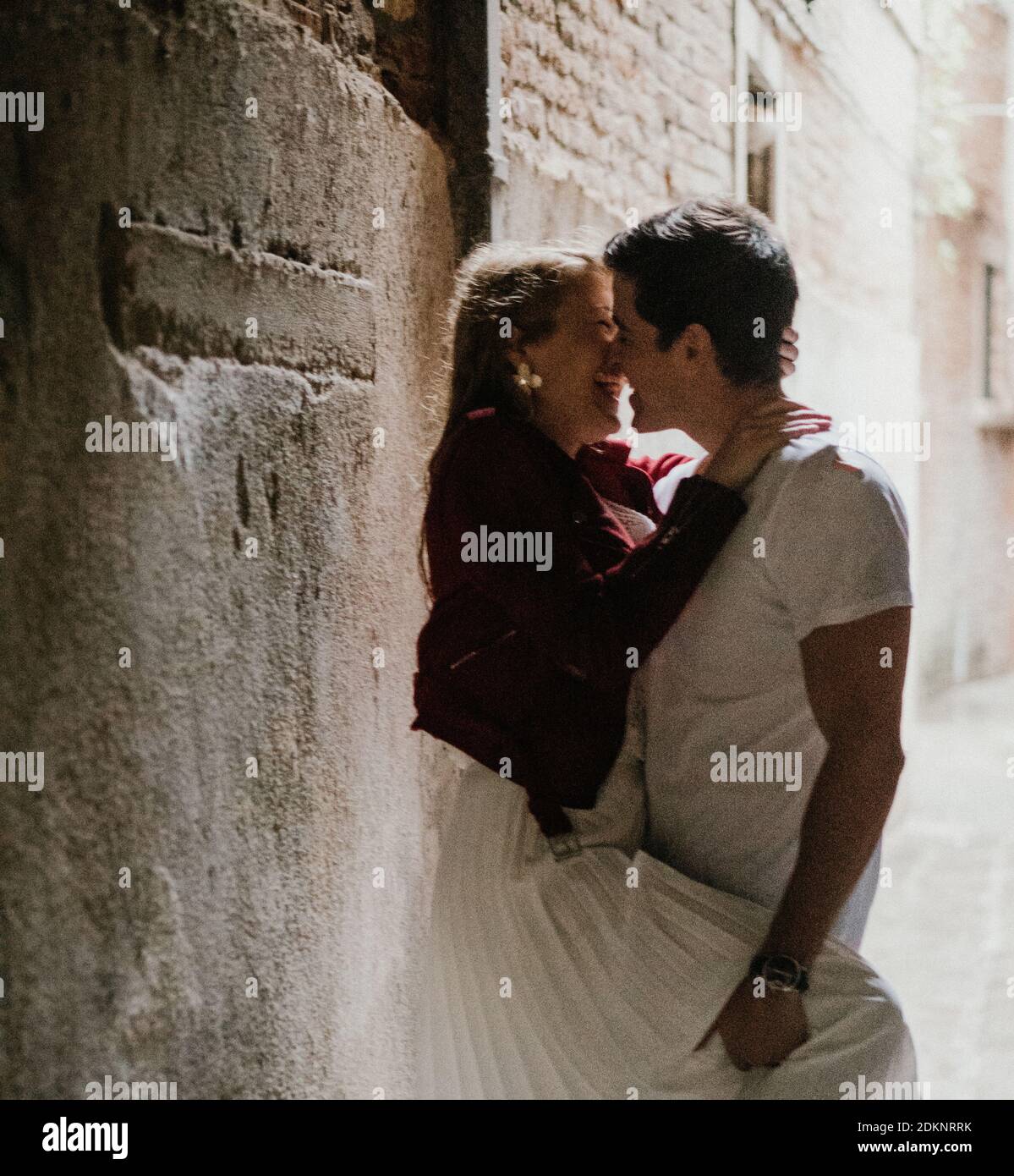 Young Couple Kissing Against Wall High Resolution Stock Photography and ...