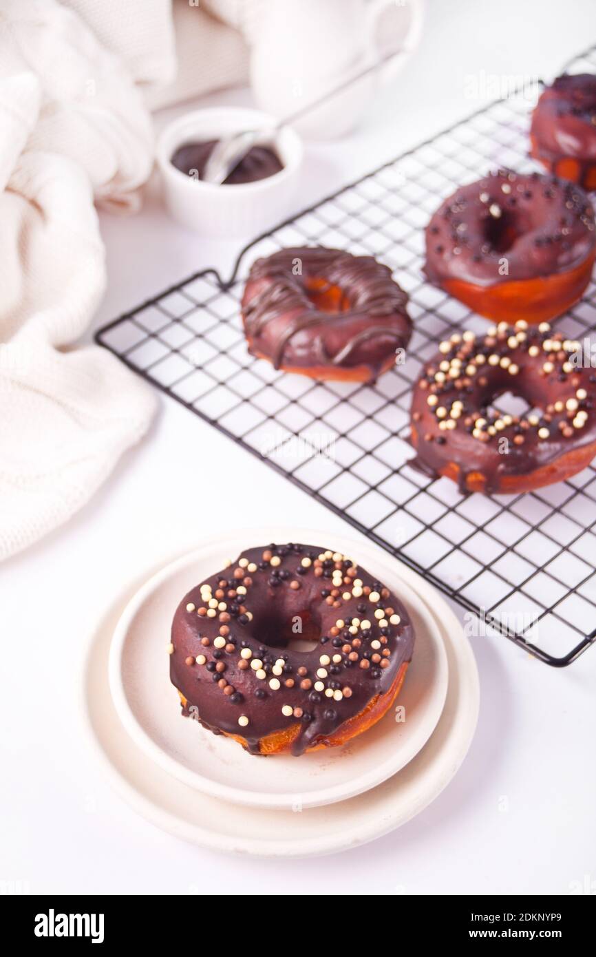 Doughnut on the baking rack and on the plate glazed with chocolate ...