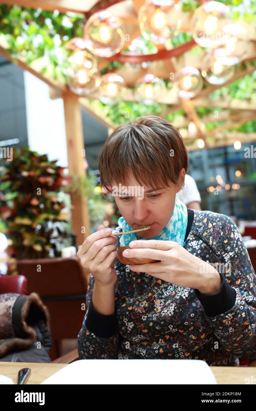 Woman smelling food plate hi-res stock photography and images - Alamy