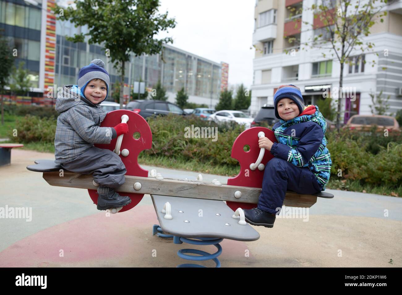 Children sitting on seesaw hi-res stock photography and images - Alamy