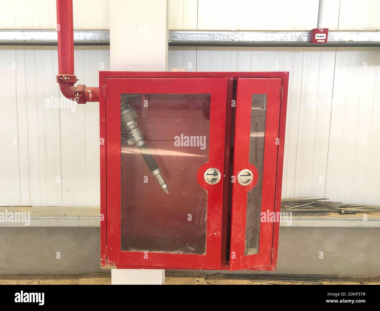 Fire extinguisher box with fire hose inside Stock Photo - Alamy