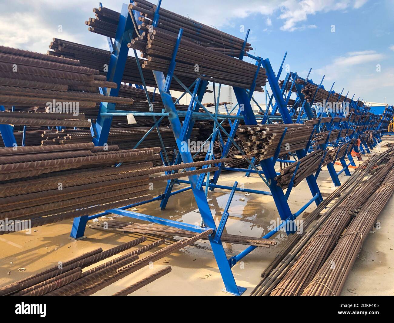 Metal reinforcement parts on metal racks at outdoor warehouse at ...