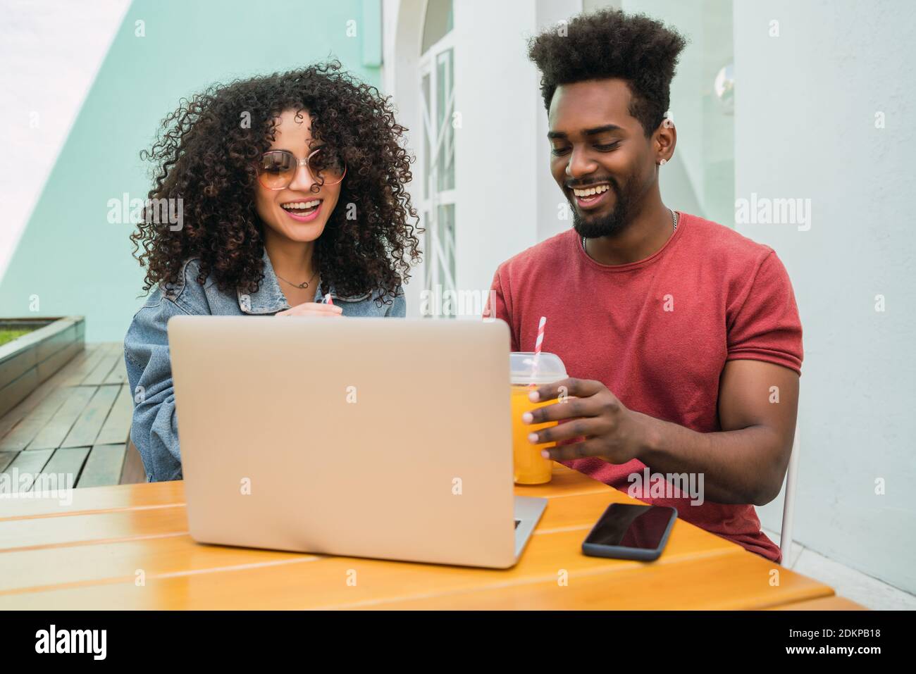 Cheerful multiracial friends using laptop hi-res stock photography and ...