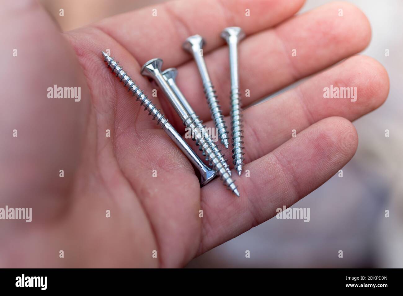 Hand holding screws hi-res stock photography and images - Alamy