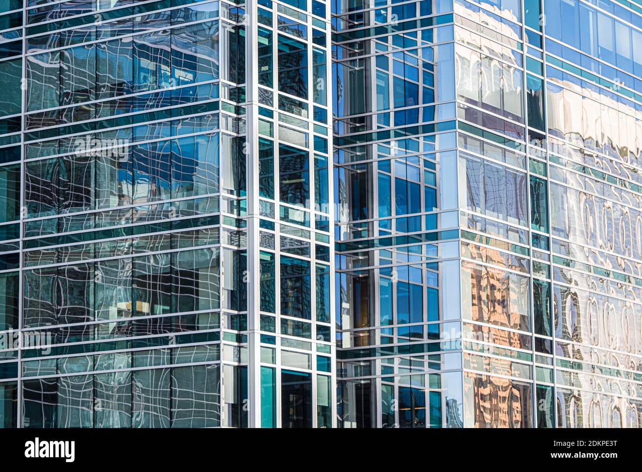 Office block glass wall reflecting sunlight in downtown Stock Photo - Alamy
