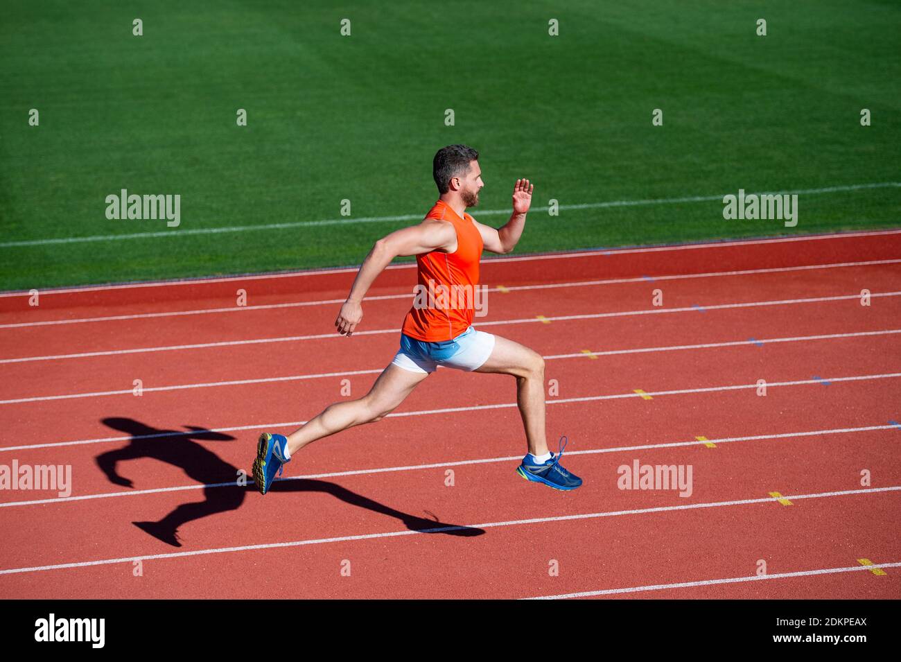 sportsman man in sportswear run fast sprinting on running track, energy ...