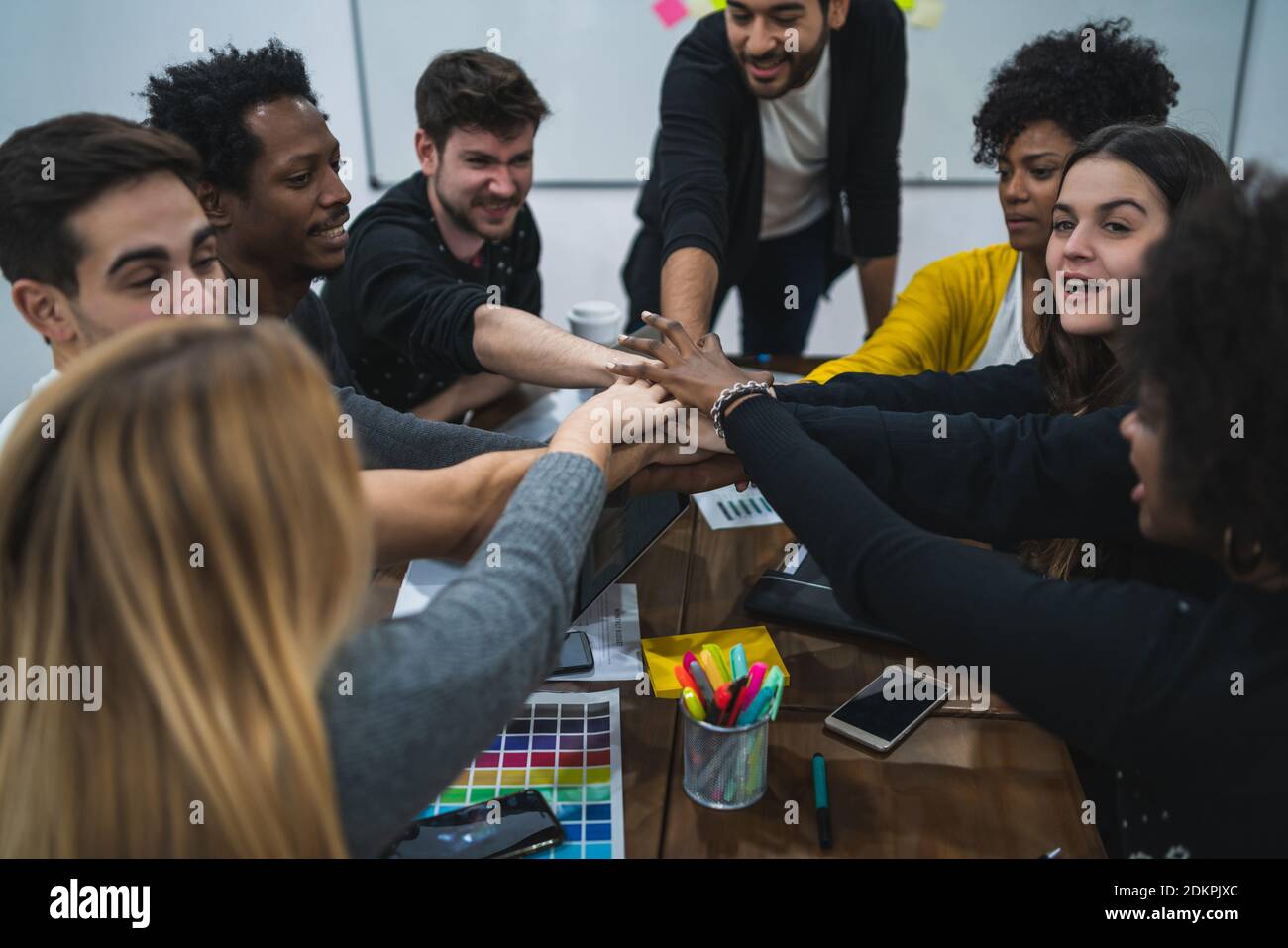 Team of work showing unity with their hand together Stock Photo - Alamy