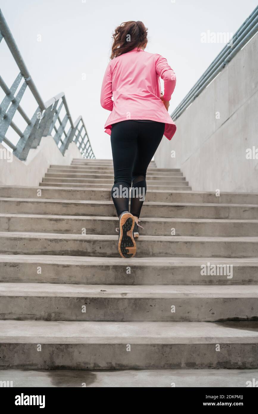 Sport woman running on stairs Stock Photo - Alamy