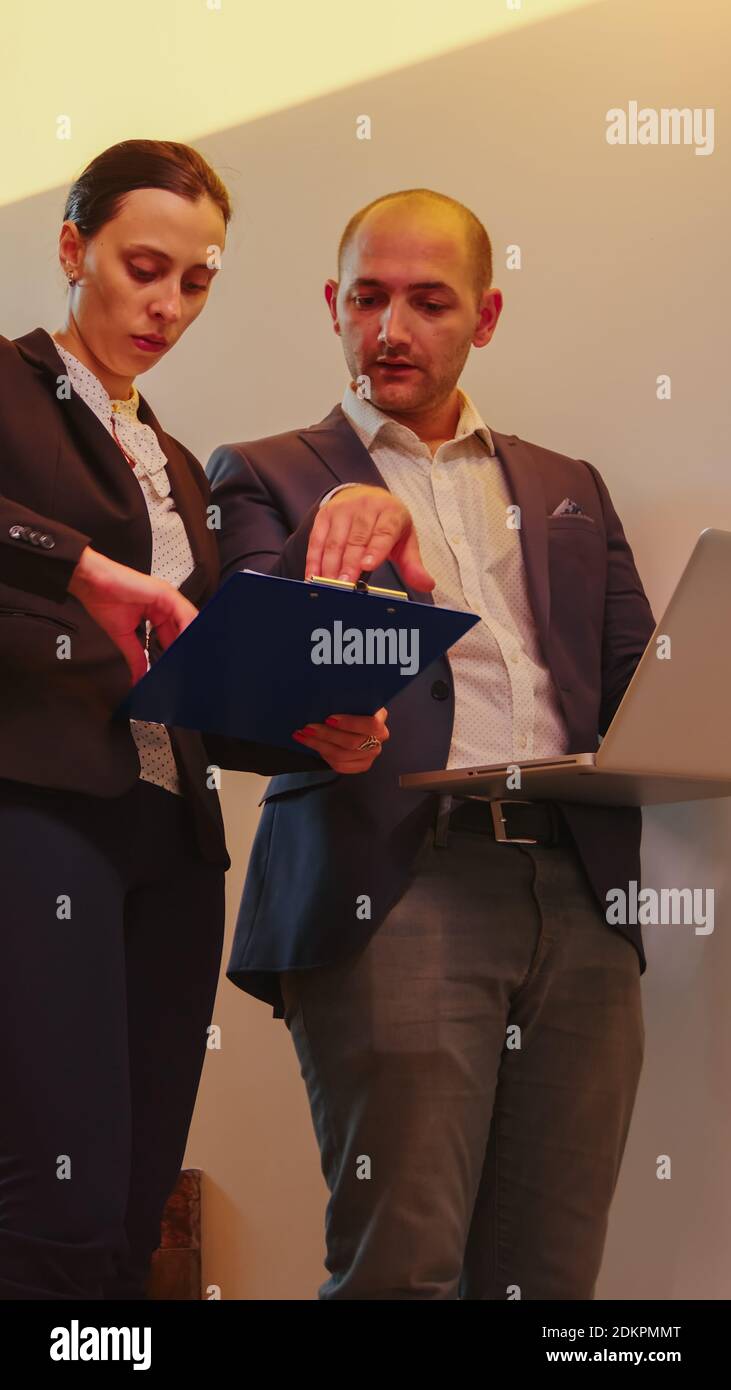 Businesswoman talking with corporate executive manager on staircase of ...