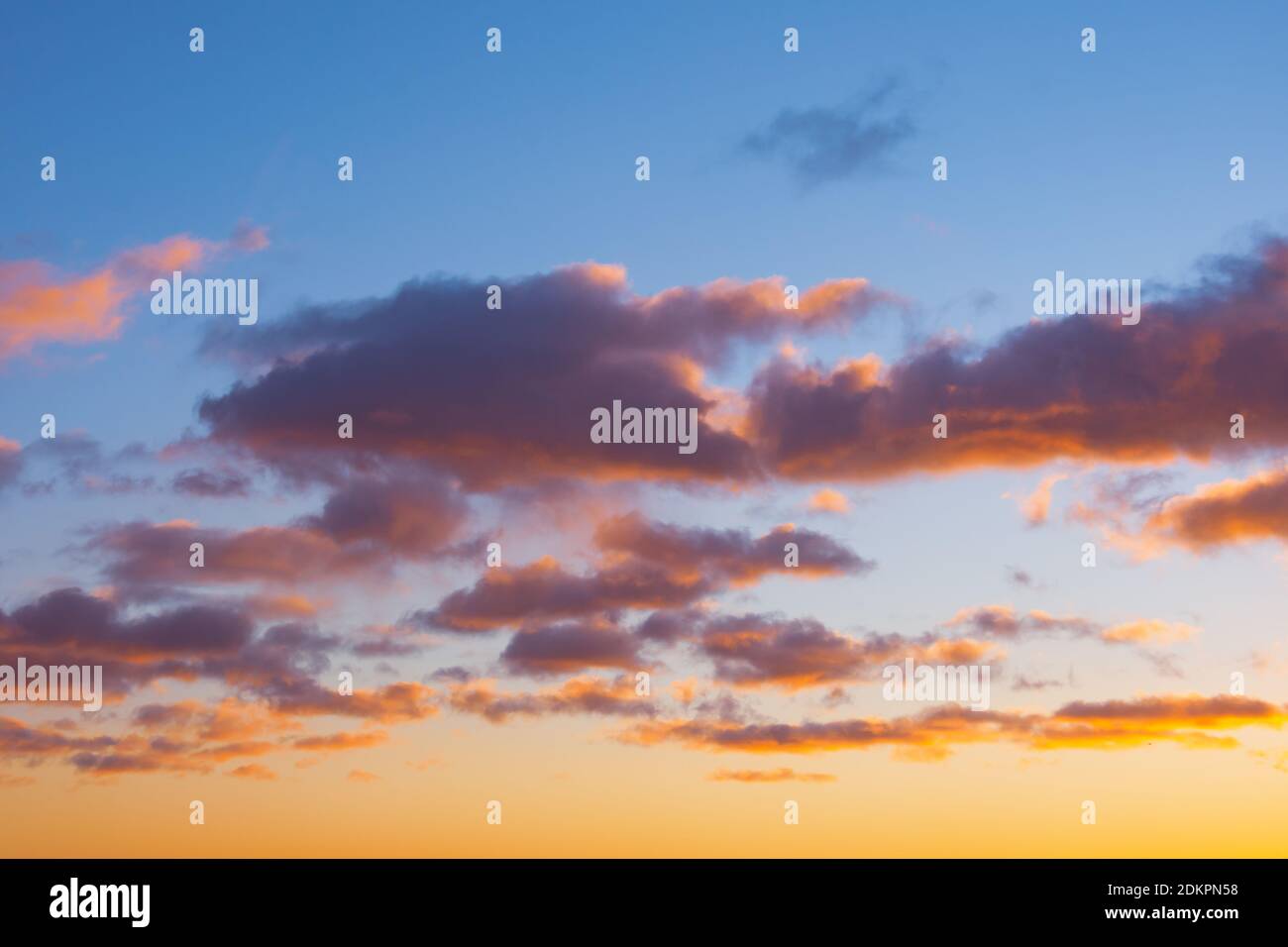 Cumulus sunset clouds with sun setting down bright gradient Stock Photo ...
