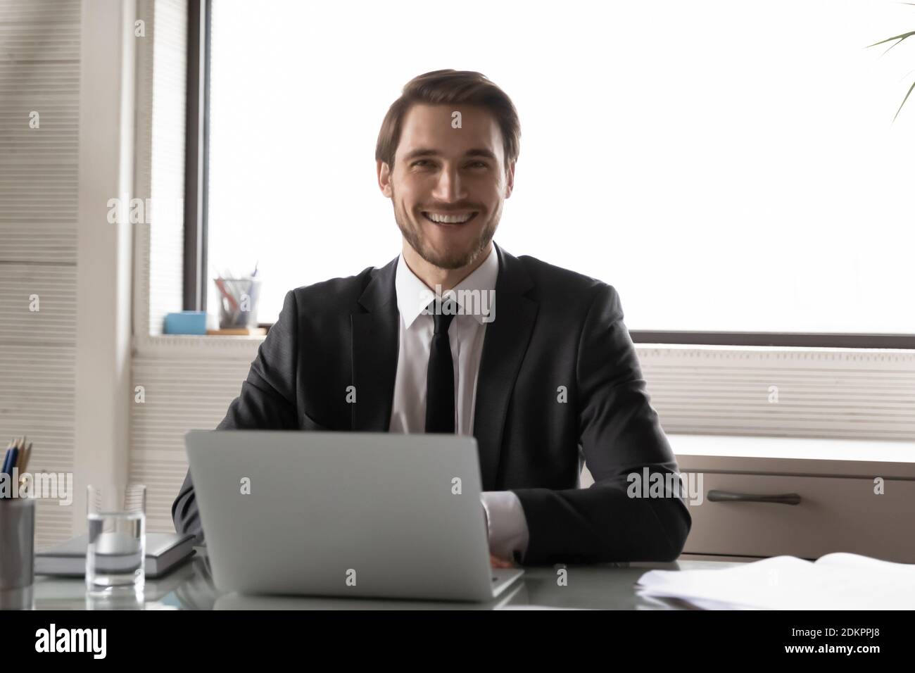 Portrait of smiling businessman posing at office workplace Stock Photo ...
