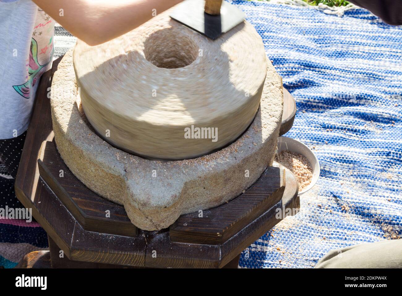 Close-up of hand operated millstone grinding wheat Stock Photo - Alamy