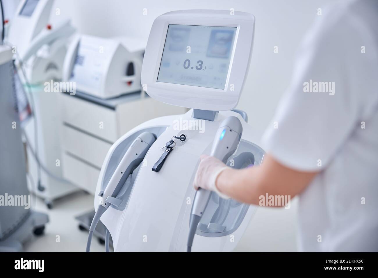 Professional high level dermatologist using modern specializing device ...