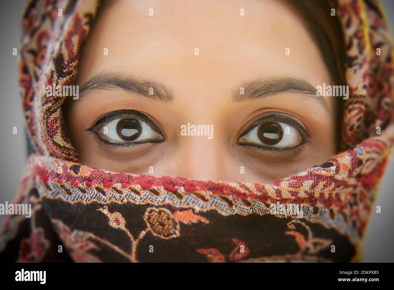 EYES OF A WOMAN WITH FACE COVERED UP USING SHAWL Stock Photo - Alamy