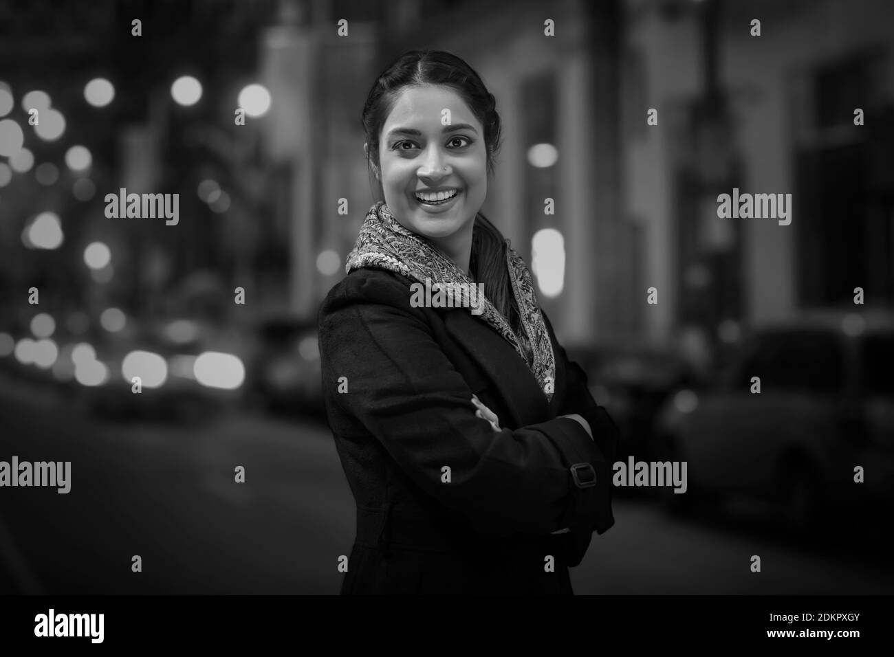 PORTRAIT OF A HAPPY WOMAN LOOKING BEHIND ON A BUSY ROAD AND SMILING ...