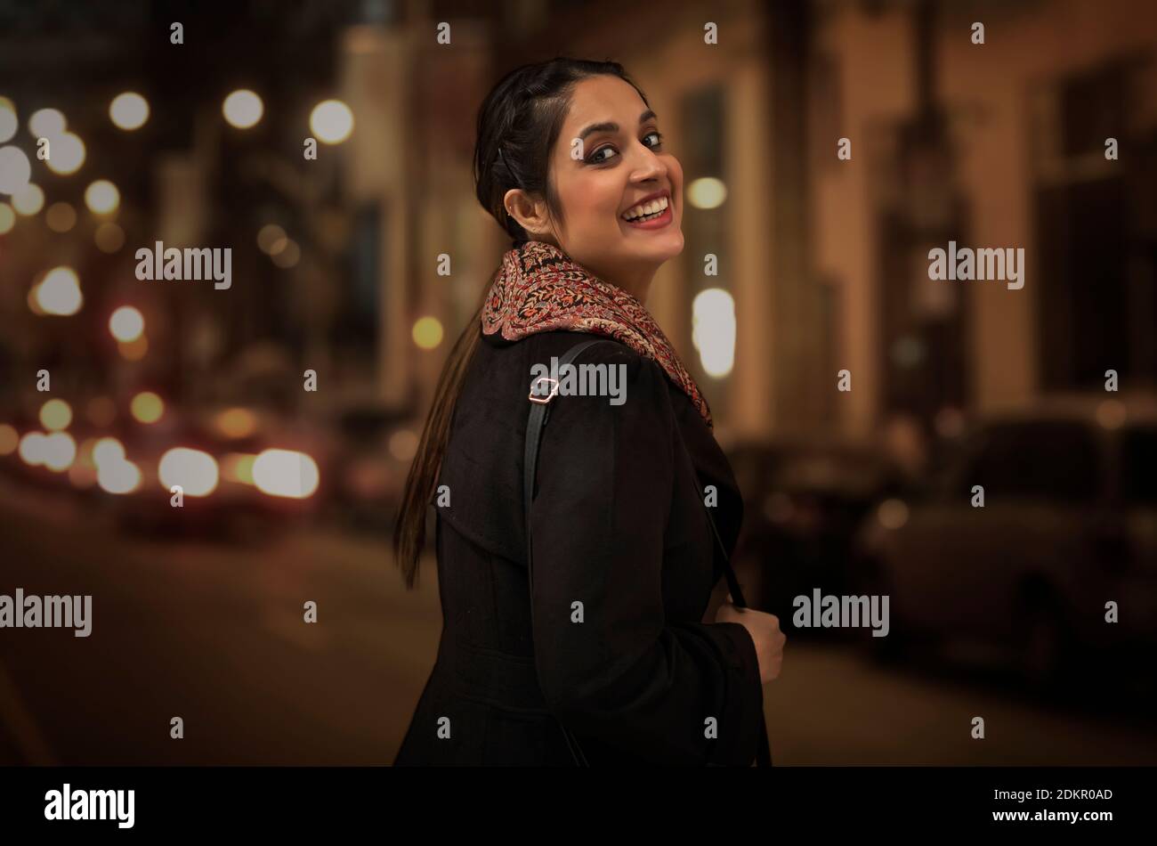 A YOUNG WOMAN LAUGHING WHILE LOOKING BEHIND Stock Photo - Alamy