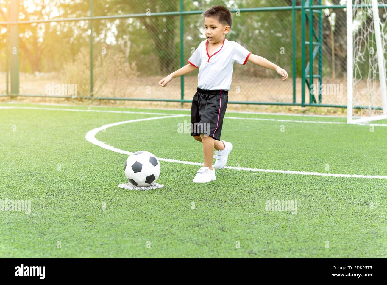 Boy age 8 playing football hi-res stock photography and images - Alamy